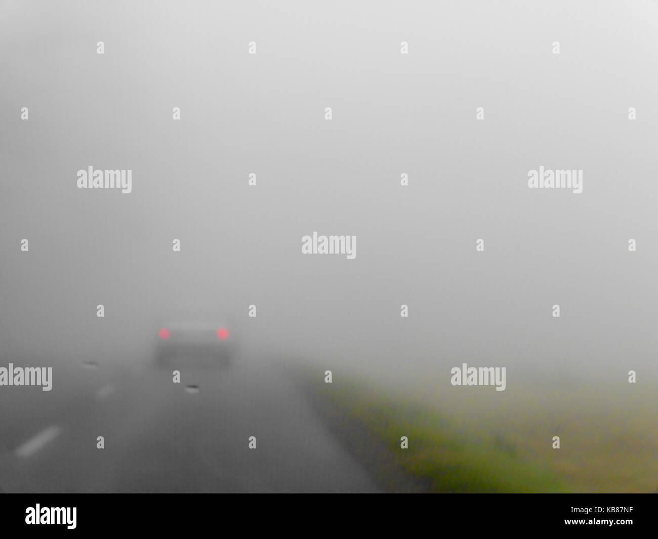 Car on a road in heavy fog Stock Photo - Alamy