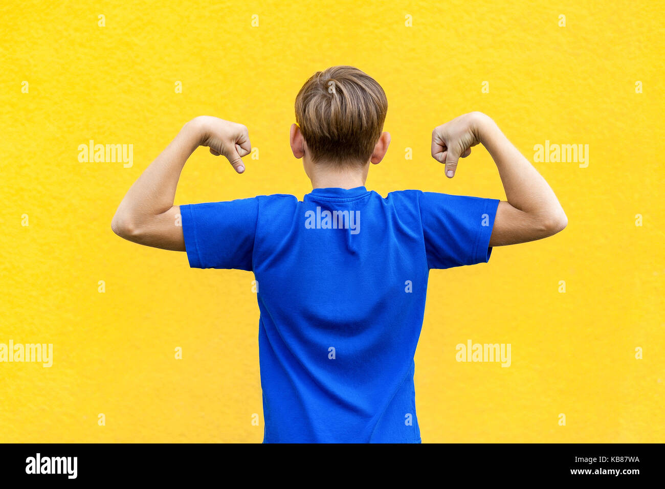 Back view of boy. Isolated on yelow background, studio shot Stock Photo ...