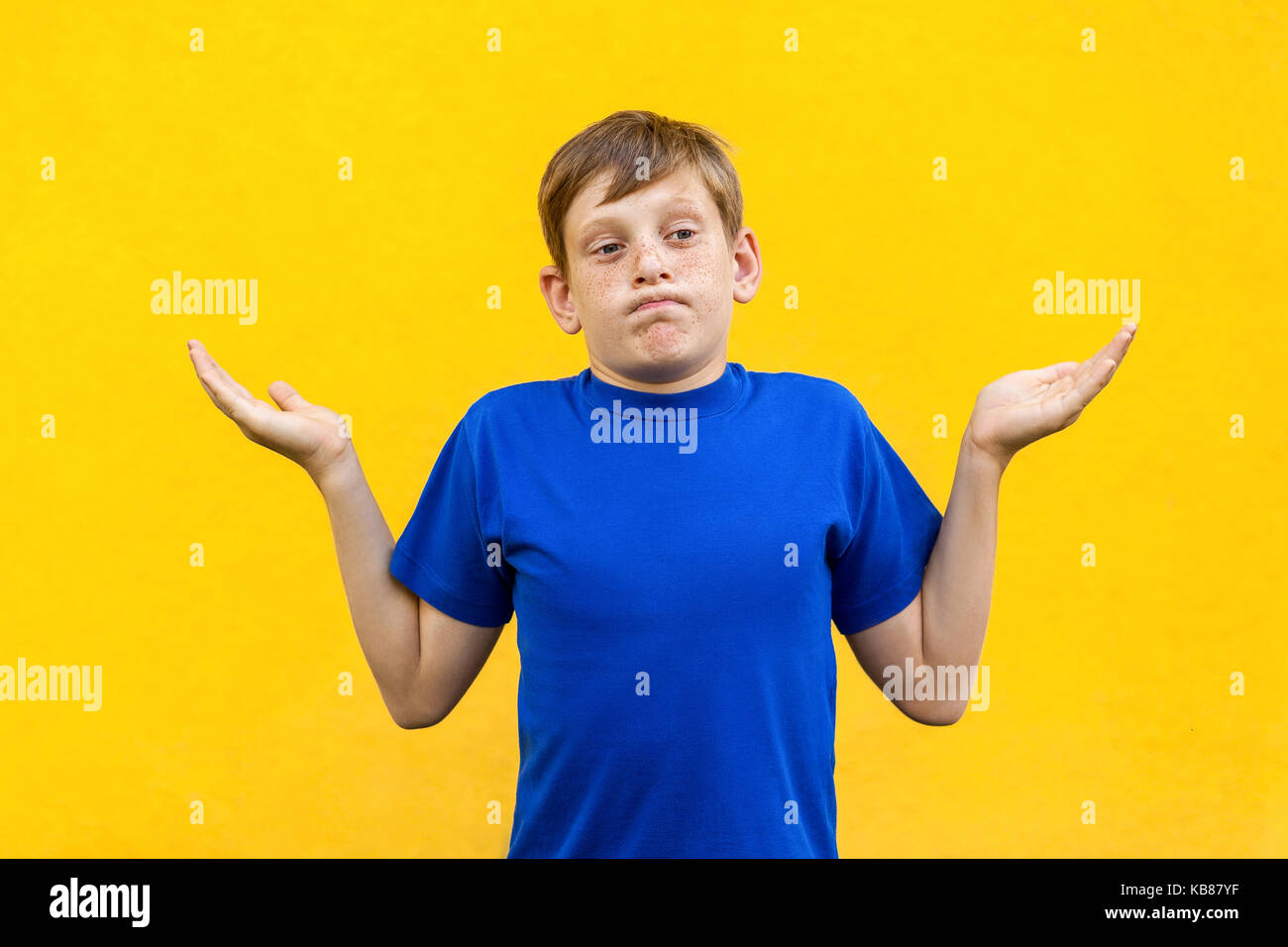 Its no my problem. Young boy with freckles looking at camera with ...