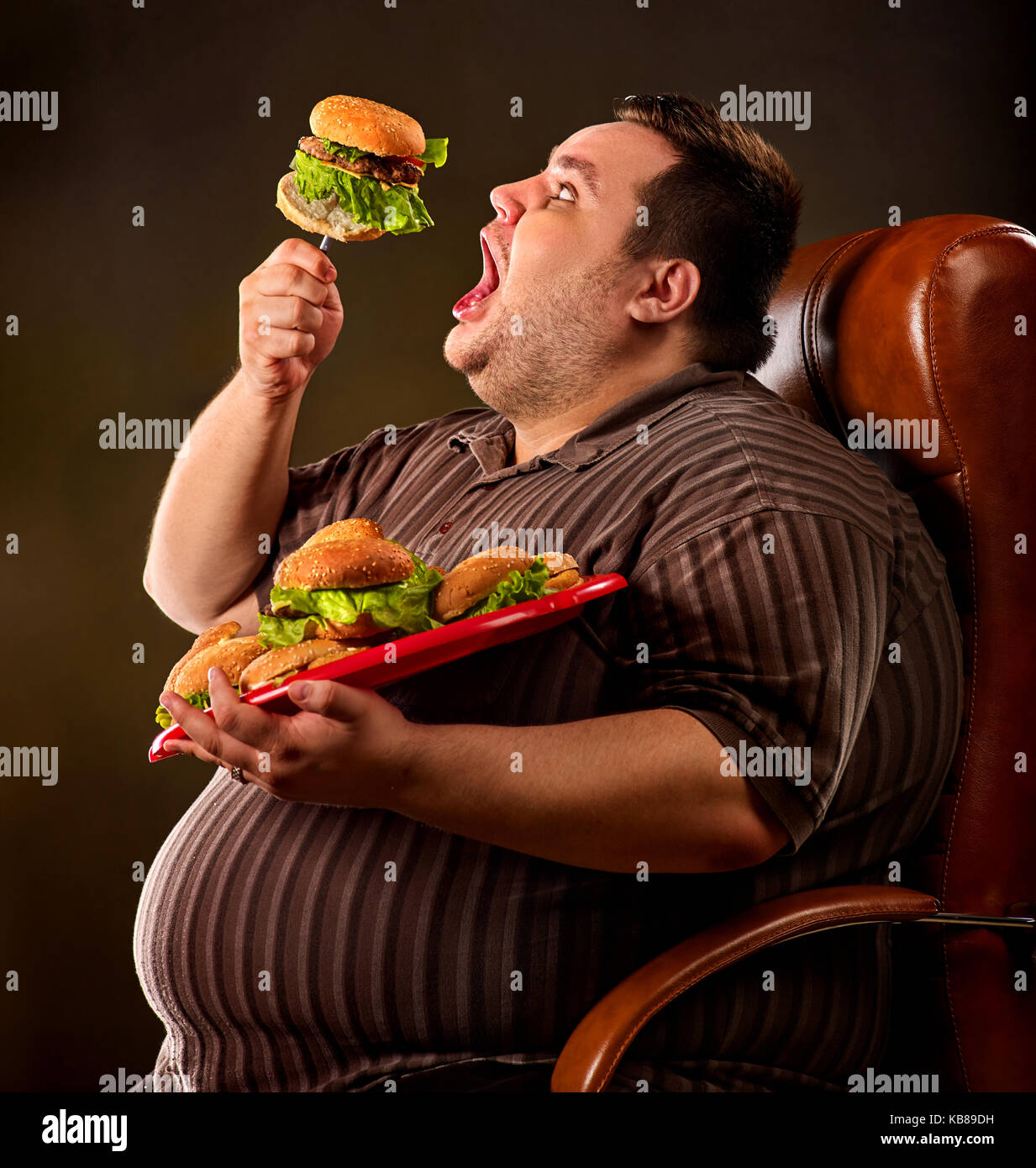 Fat man eating fast food hamberger. Breakfast for overweight person ...