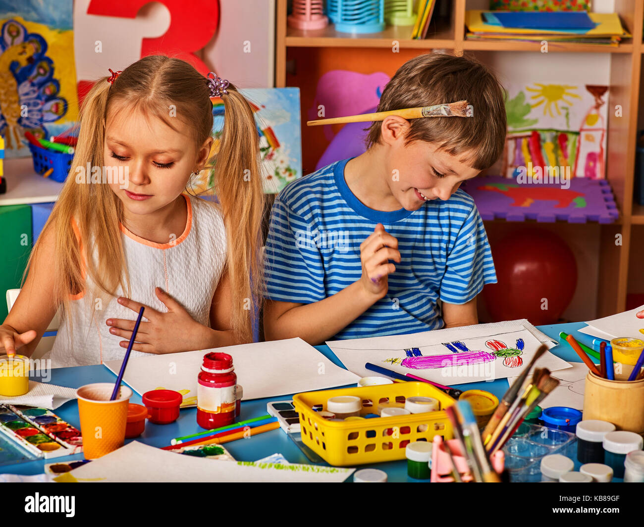 Small student child painting in art school class Stock Photo - Alamy