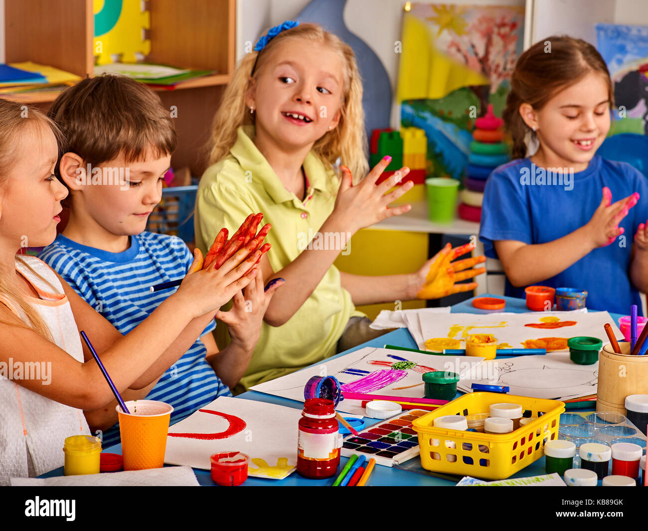 Small students girl finger painting in art school class Stock Photo - Alamy