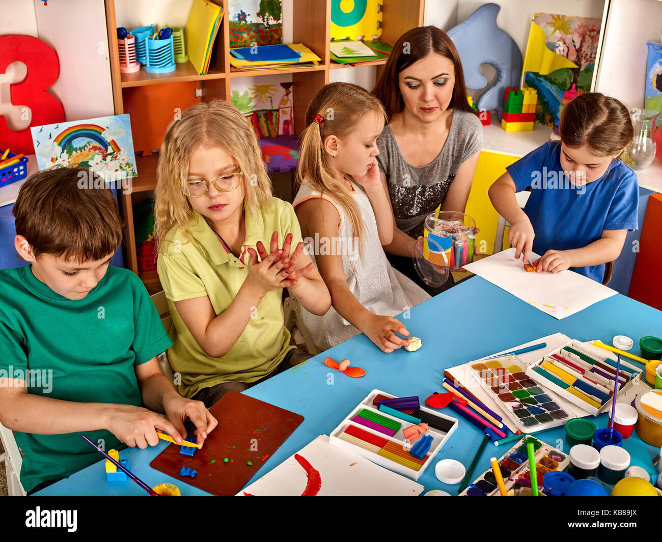 Plasticine modeling clay in children class. Teacher teaches in school ...