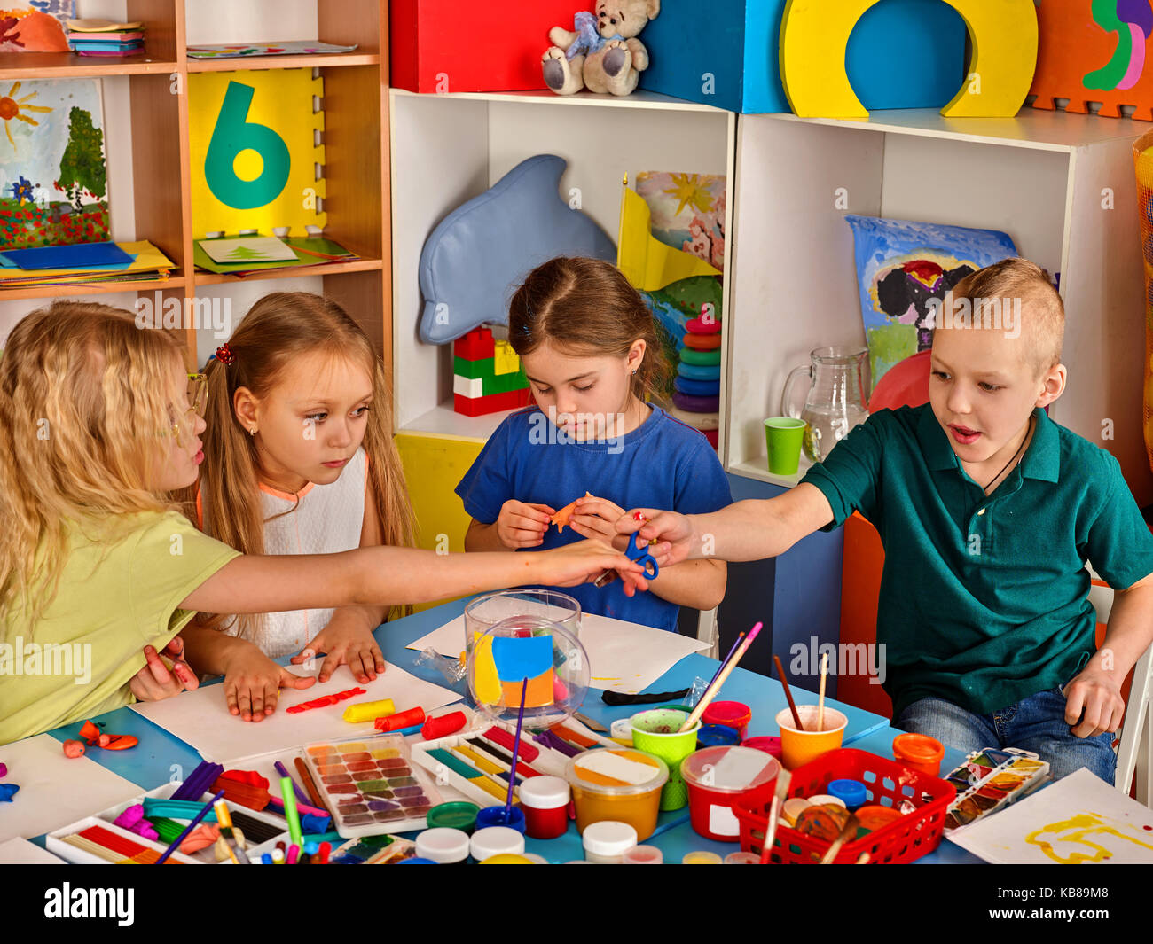 Plasticine modeling clay in children class. Teacher teaches in school ...
