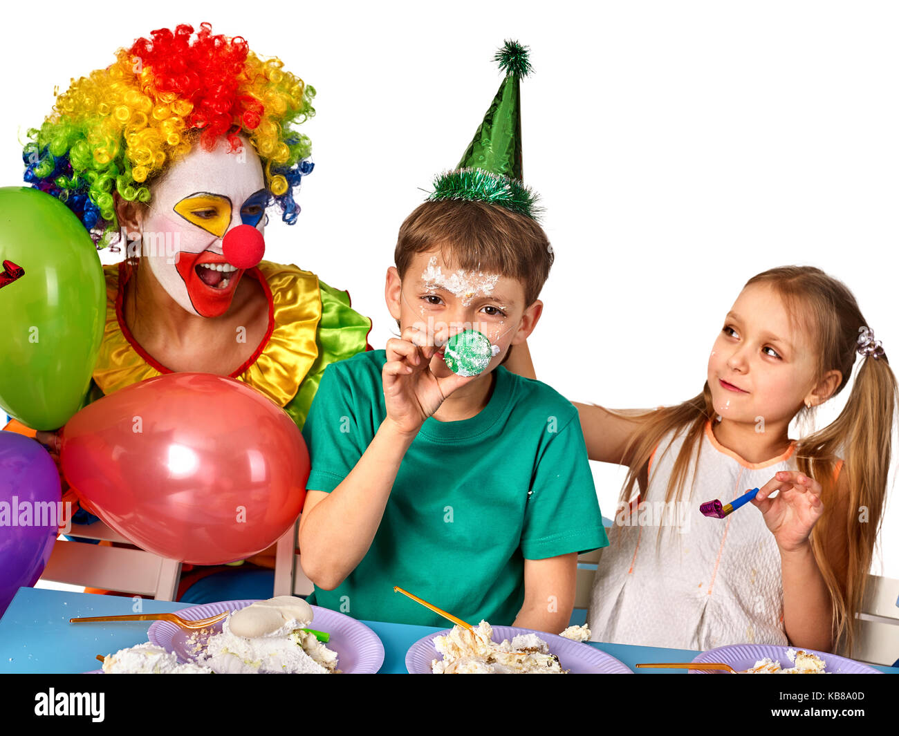 Birthday child clown eating cake with boy together. Kid with messy face ...