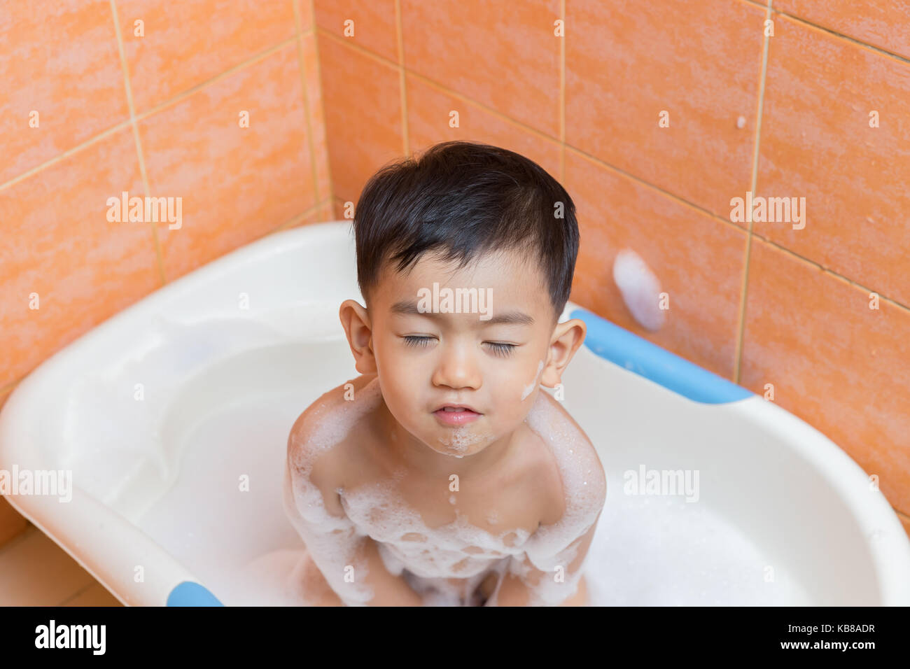 Closeup 2 year old Child bathing in bathtub Stock Photo - Alamy