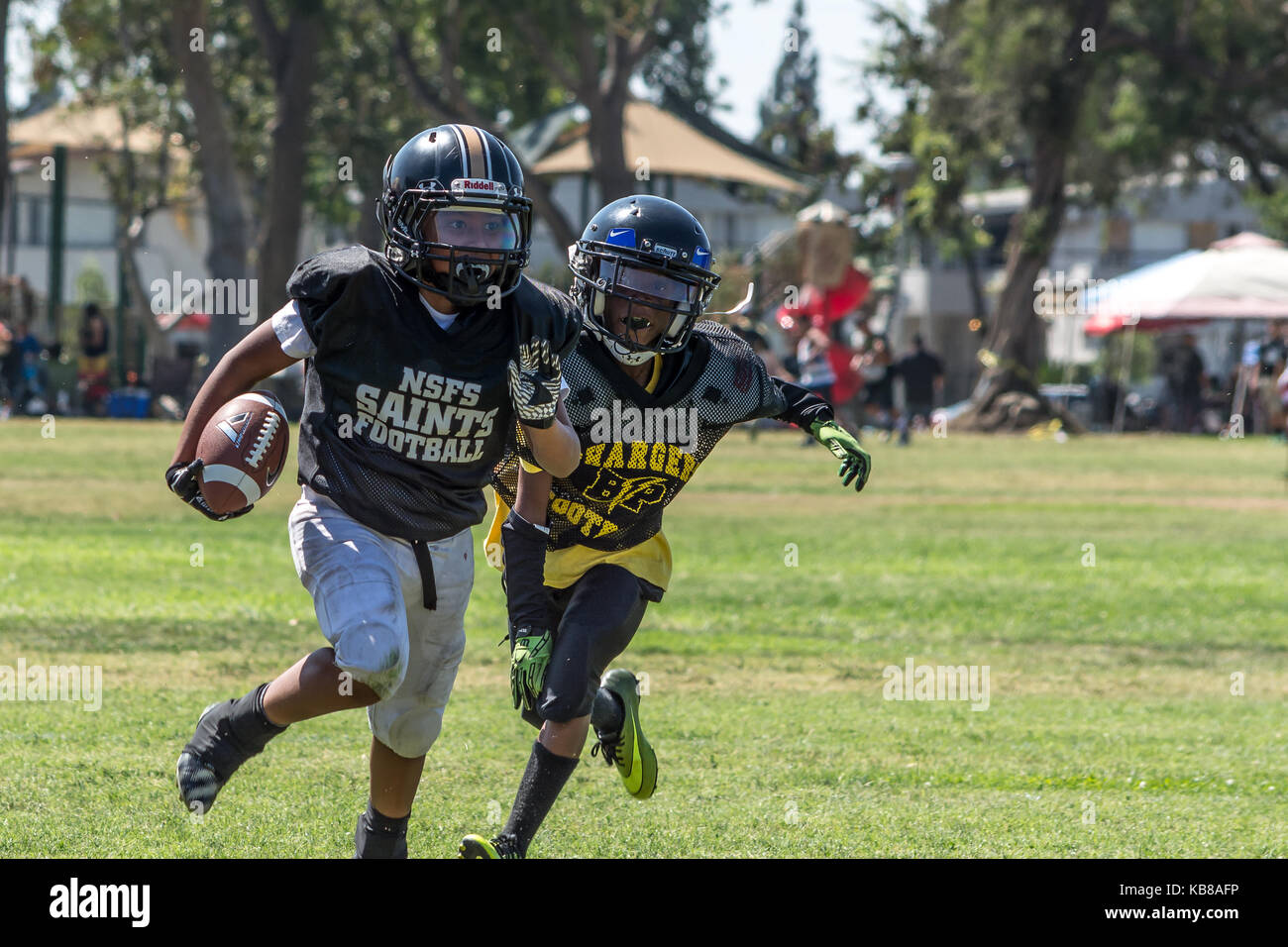 Football player from opposite team runs after player for a tackle Stock ...