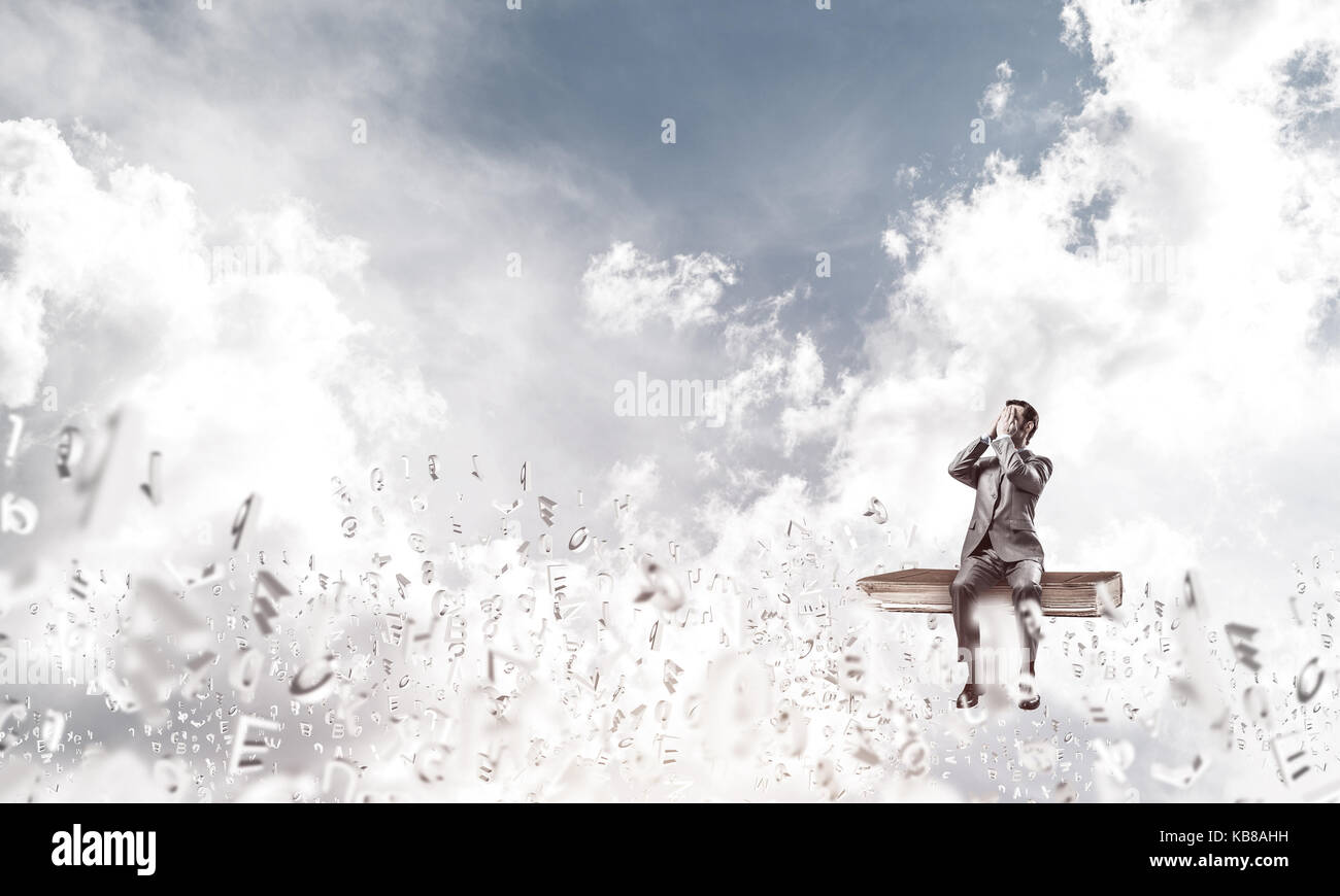 Young man floating in sky and do not want to see anything Stock Photo ...