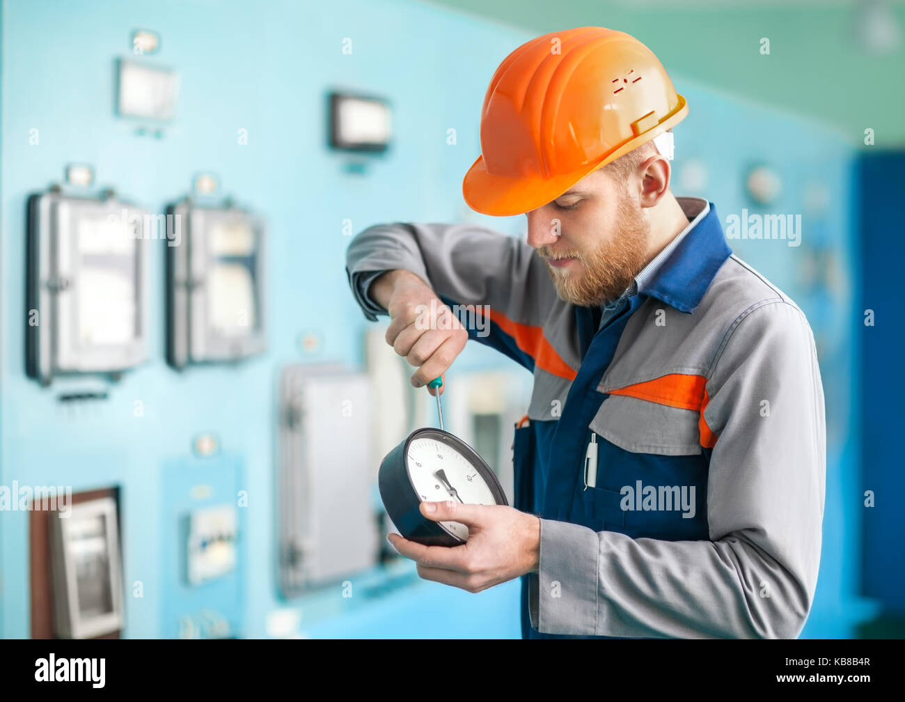 Portrait of young engineer repairing equipment at control room in ...