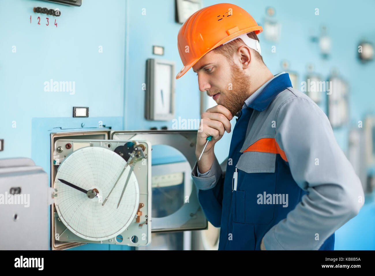 Portrait of young engineer repairing equipment at control room in ...