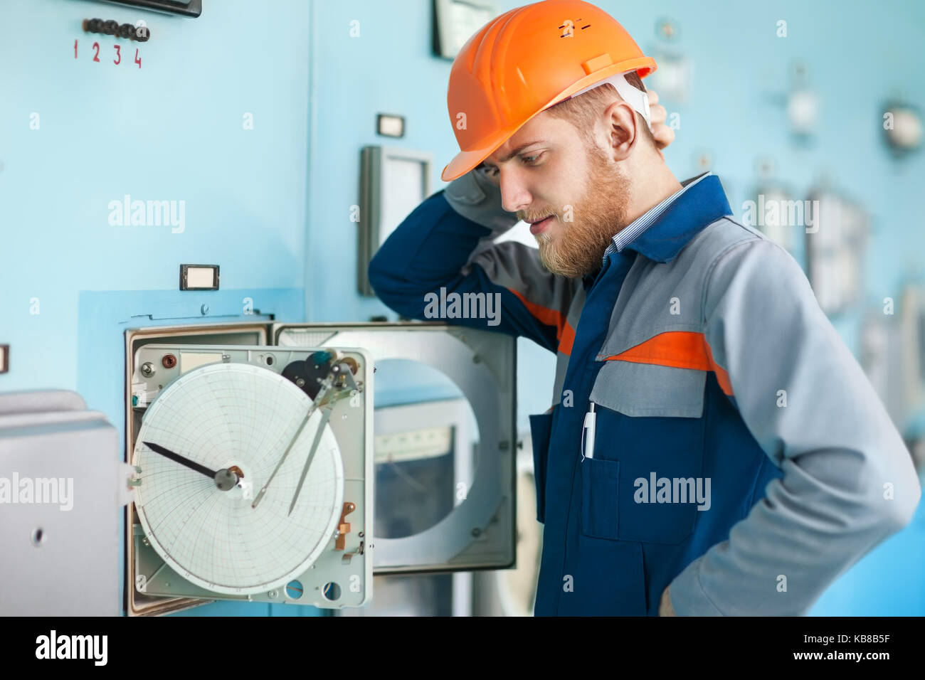 Portrait of young engineer repairing equipment at control room in ...