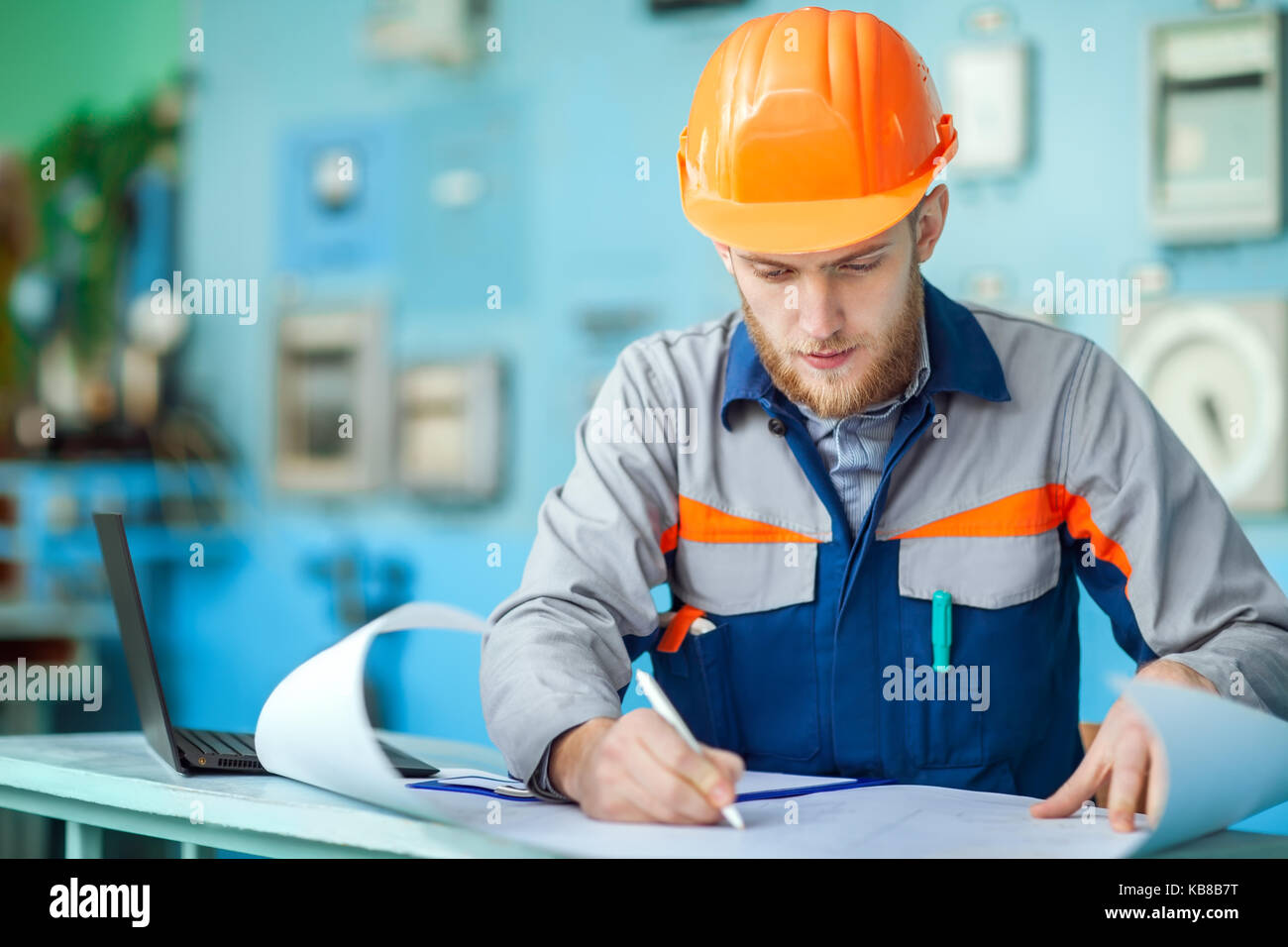 Portrait of young engineer working with blueprint at control room Stock ...