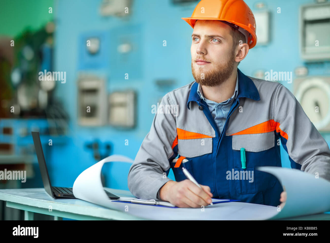 Portrait of young engineer working with blueprint at control room Stock ...