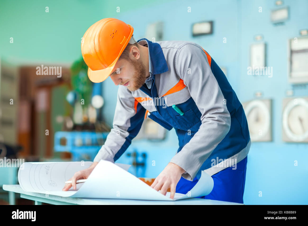 Portrait of young engineer working with blueprint at control room Stock ...