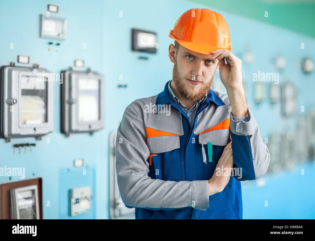 Portrait of young engineer saluting at control room in factory Stock ...