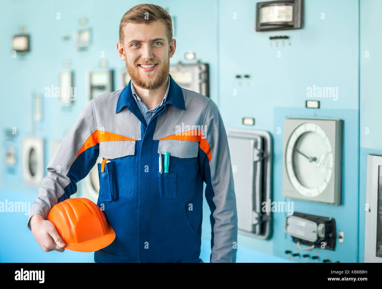 Portrait of young happy engineer in control room in factory Stock Photo ...