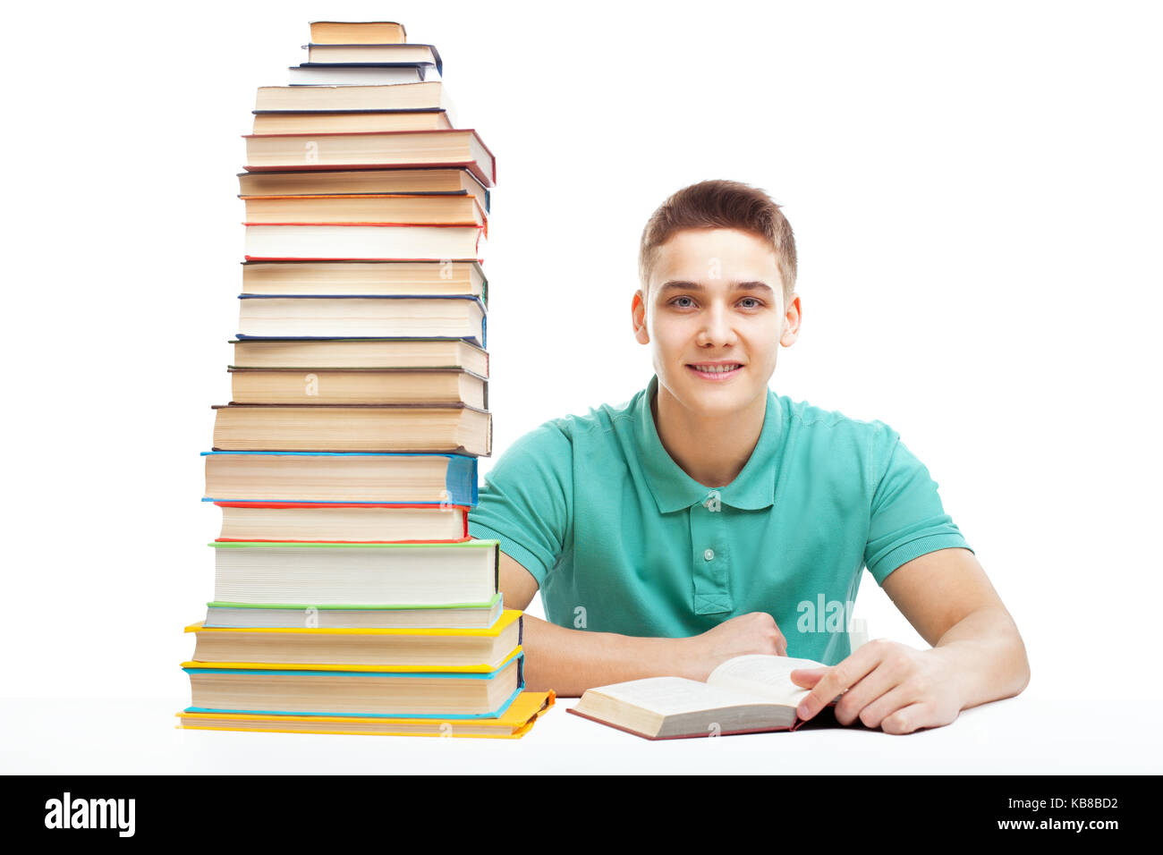 Student studying at a table with high books stack isolated on white ...