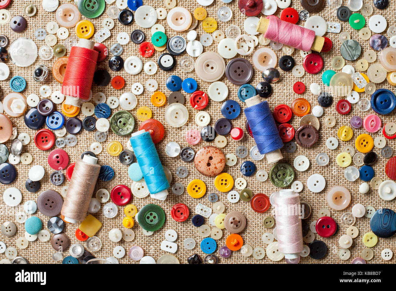 sewing buttons and spools of threads background Stock Photo - Alamy