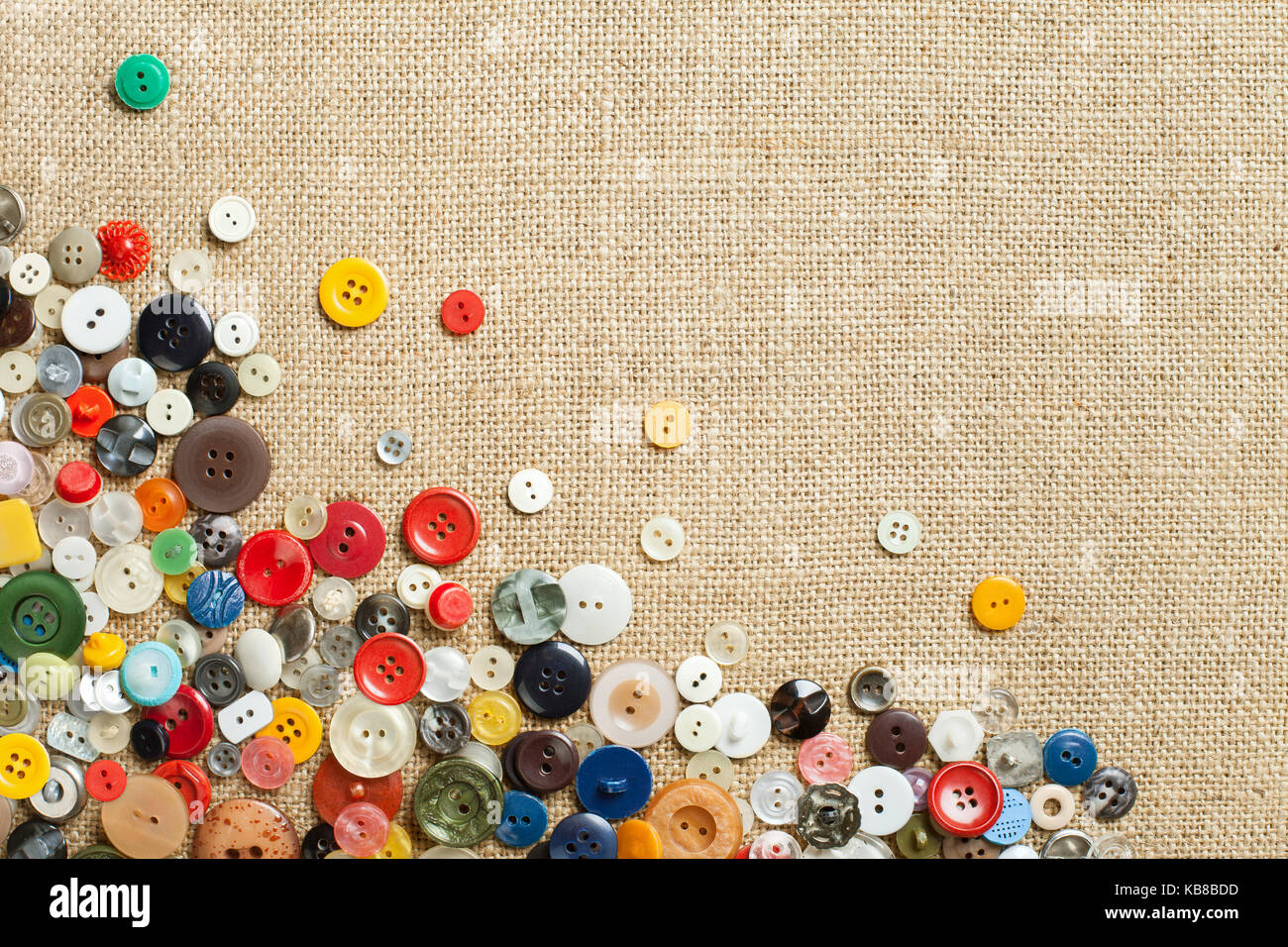 Collection of colourful sewing buttons on fabric texture background ...