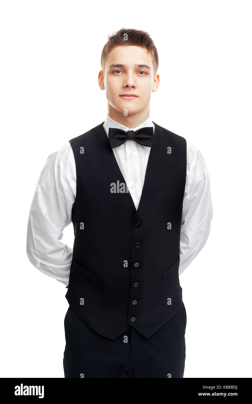 Portrait of young smiling waiter standing with hands behind his back ...