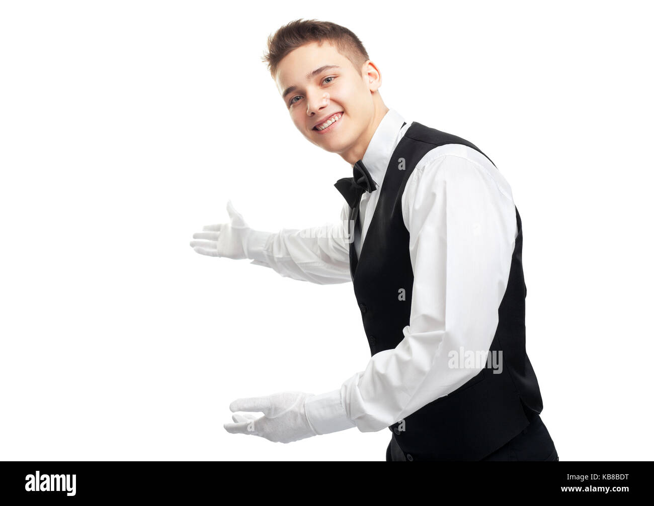 Portrait of young happy smiling waiter gesturing welcome isolated on ...