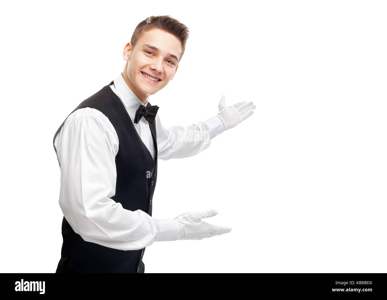 Portrait of young happy smiling waiter gesturing welcome isolated on ...