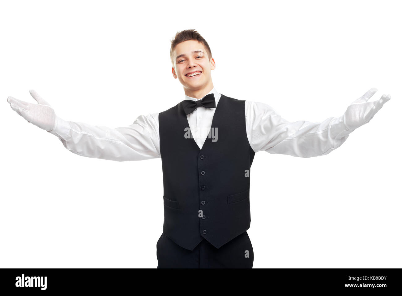 Portrait of young happy smiling waiter opens his arms in welcome ...