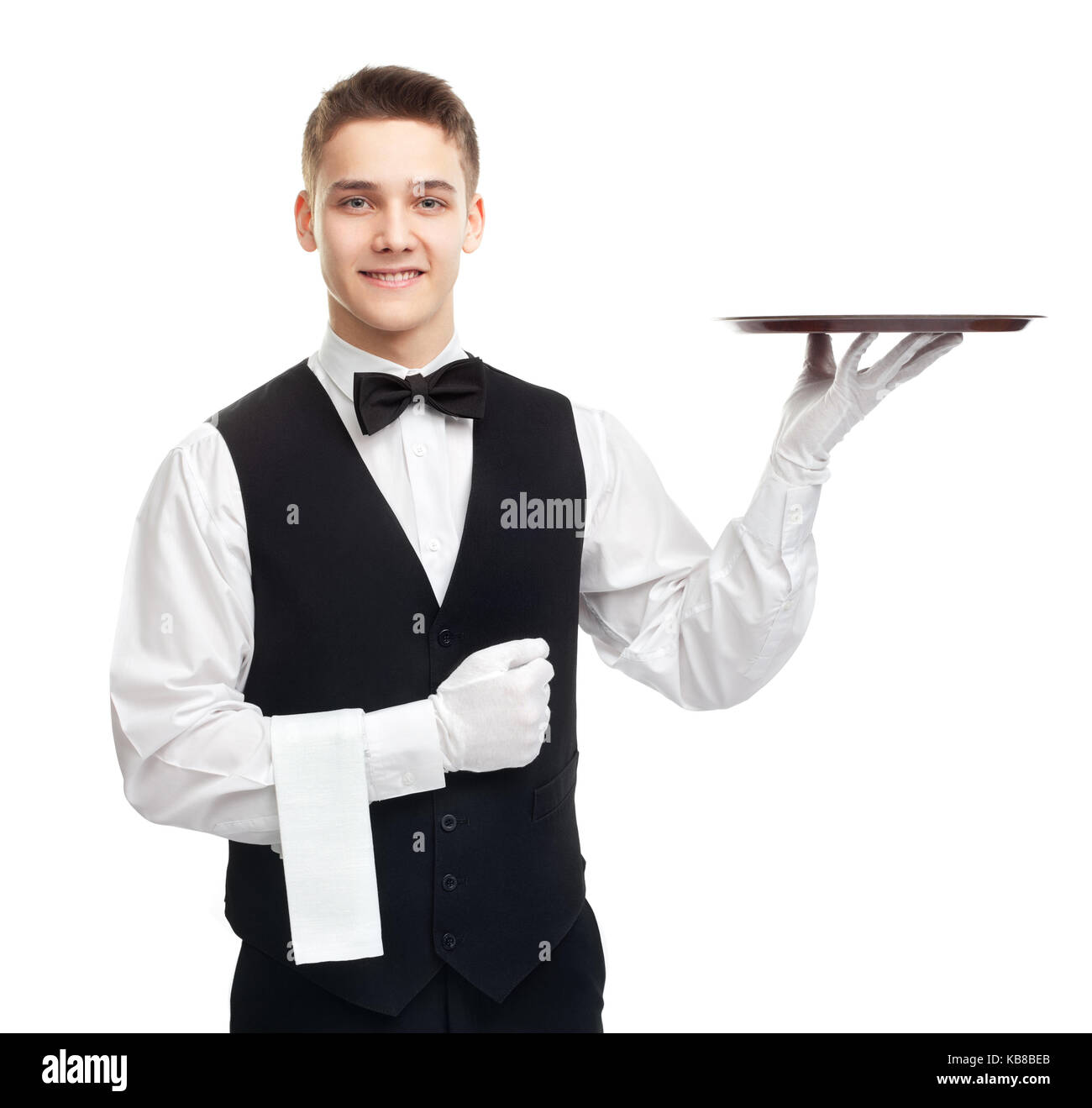 Portrait of young happy smiling waiter with empty tray isolated on ...