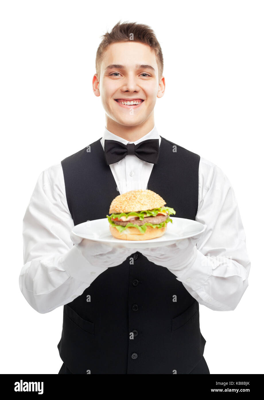 Portrait of young happy smiling waiter holding hamburger on plate ...