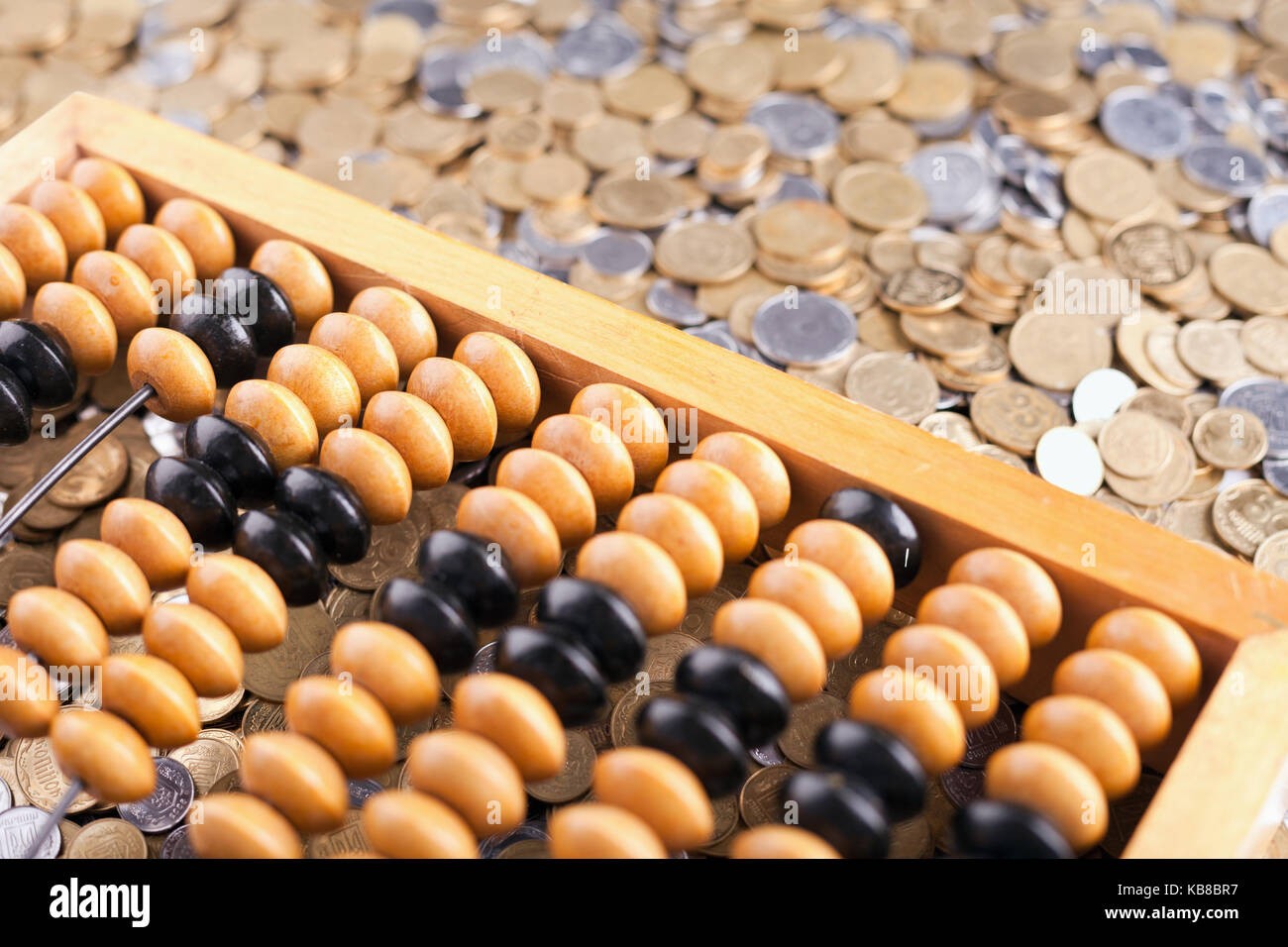 Accounting abacus and heap of coins Stock Photo - Alamy