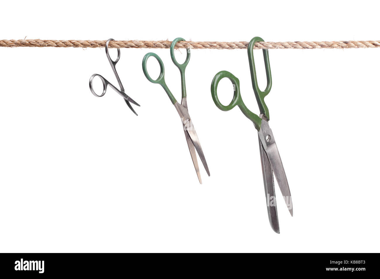Three scissors hanging on a rope isolated on white background Stock ...