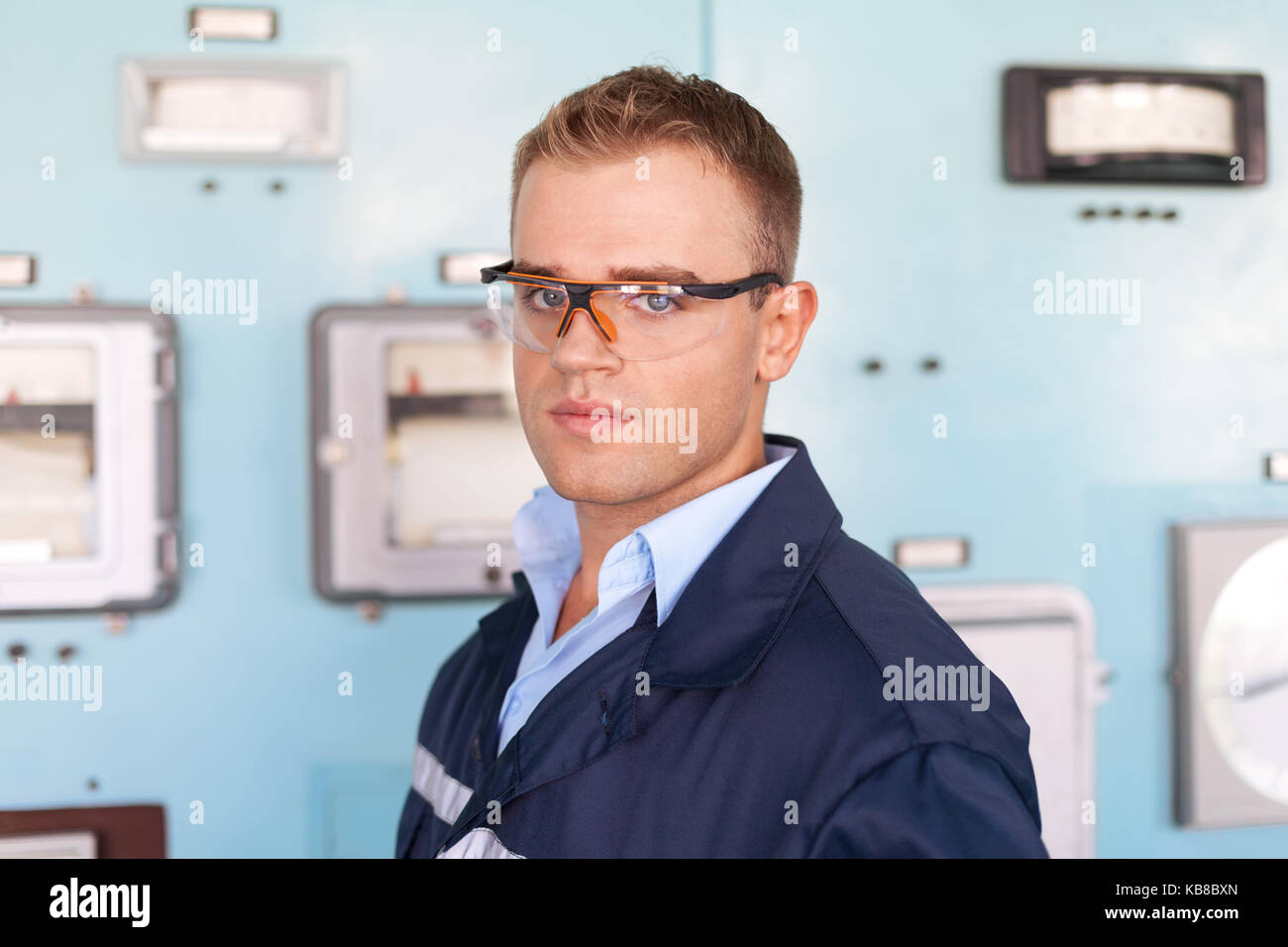 Young engineer wearing a safety glasses at control room Stock Photo - Alamy