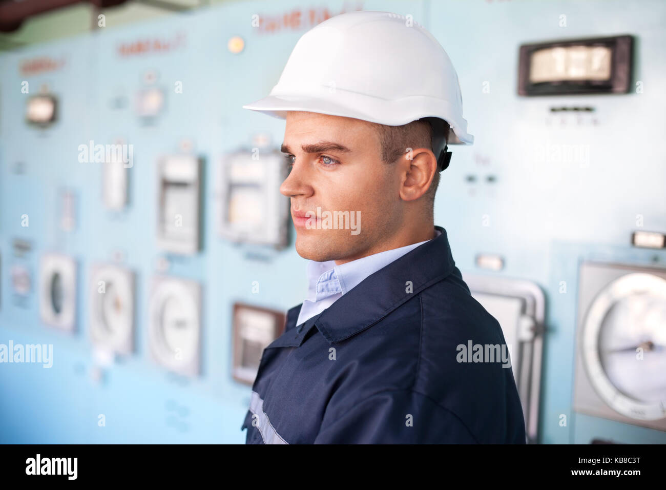 Portrait of young engineer with helmet at control room Stock Photo - Alamy