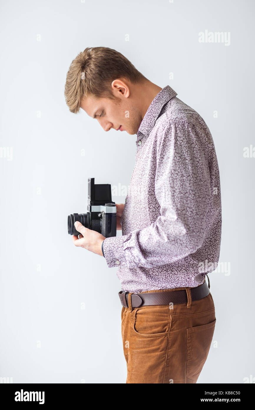 Portrait of handsome man with old medium format camera in studio Stock ...