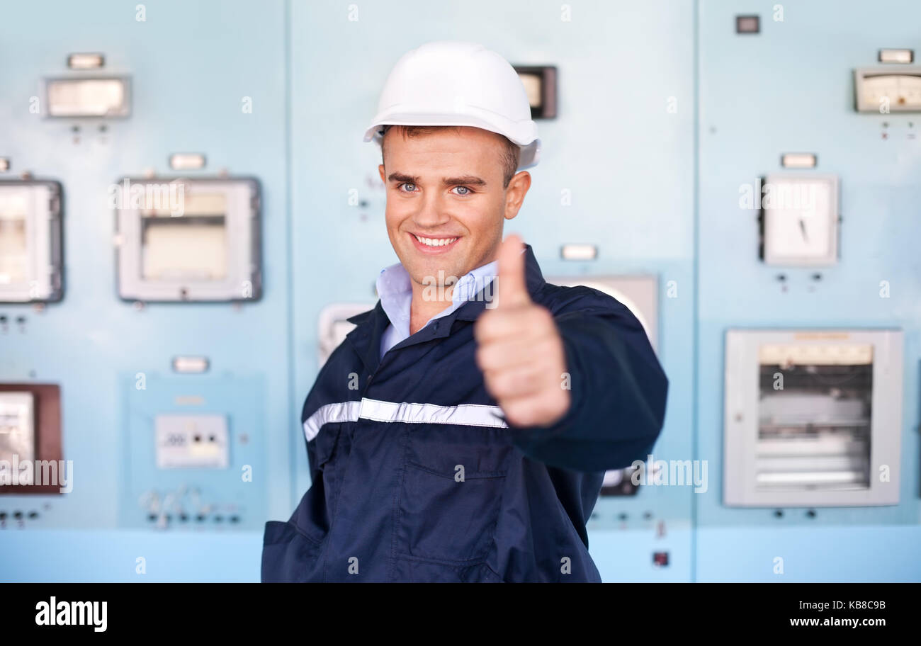 Portrait of young engineer with thumbs up at control room Stock Photo ...