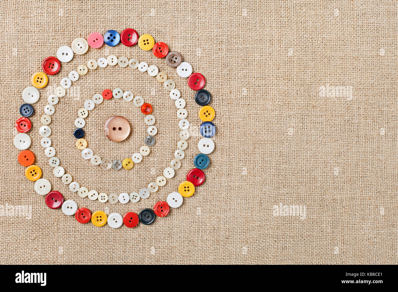 Circles of colorful sewing buttons on fabric texture background with ...