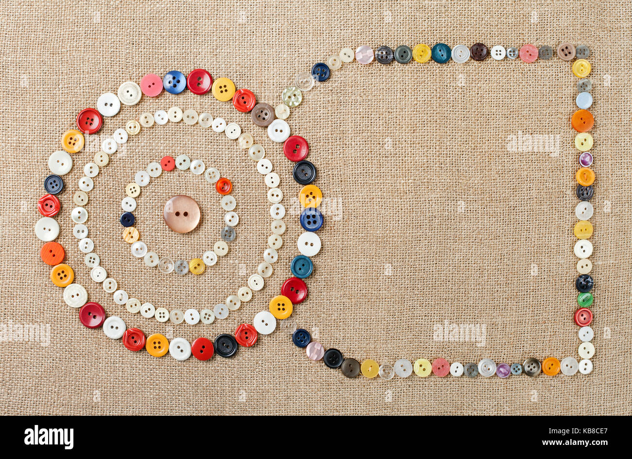 Circles of colorful sewing buttons on fabric texture background with ...