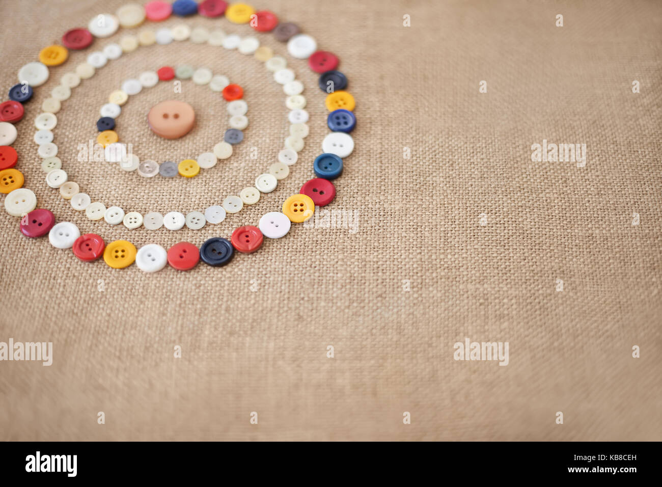 Circles of colorful sewing buttons on fabric texture background with ...
