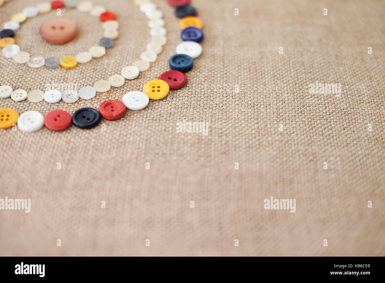 Circles of colorful sewing buttons on fabric texture background with ...