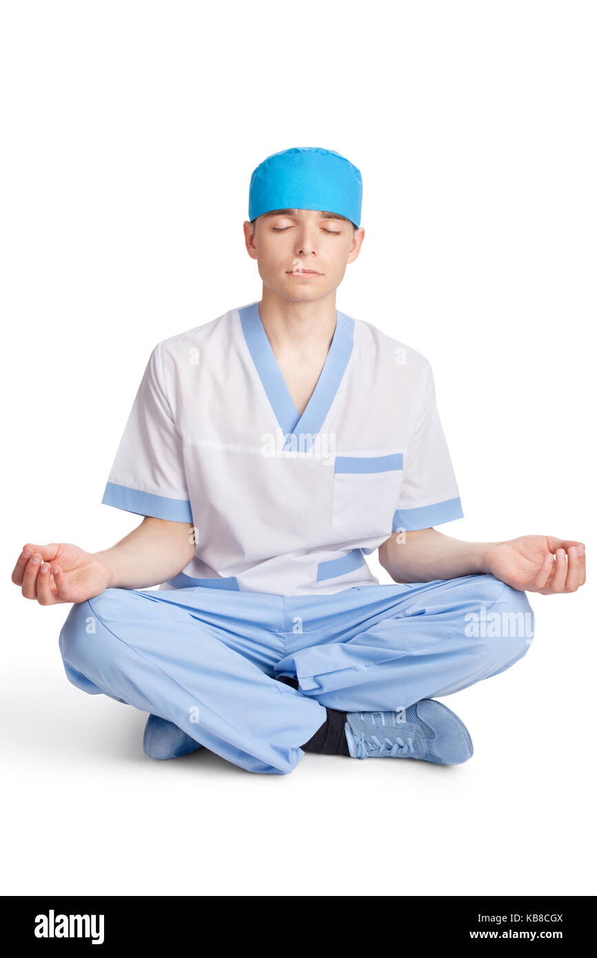 medical doctor meditating in lotus pose isolated on white background ...