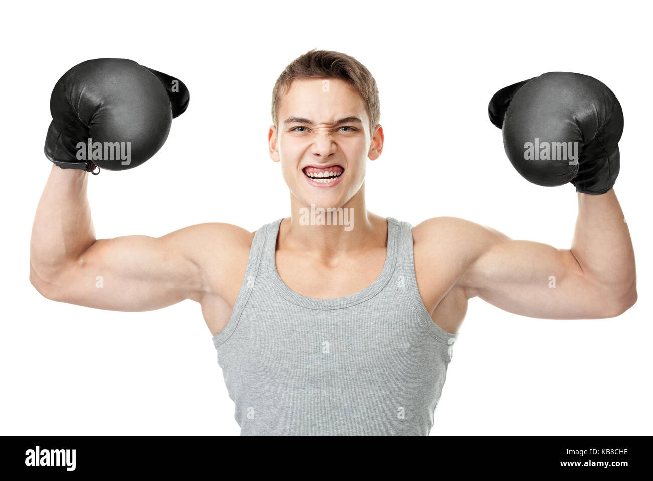 Portrait of angry young boxer showing biceps isolated on white ...