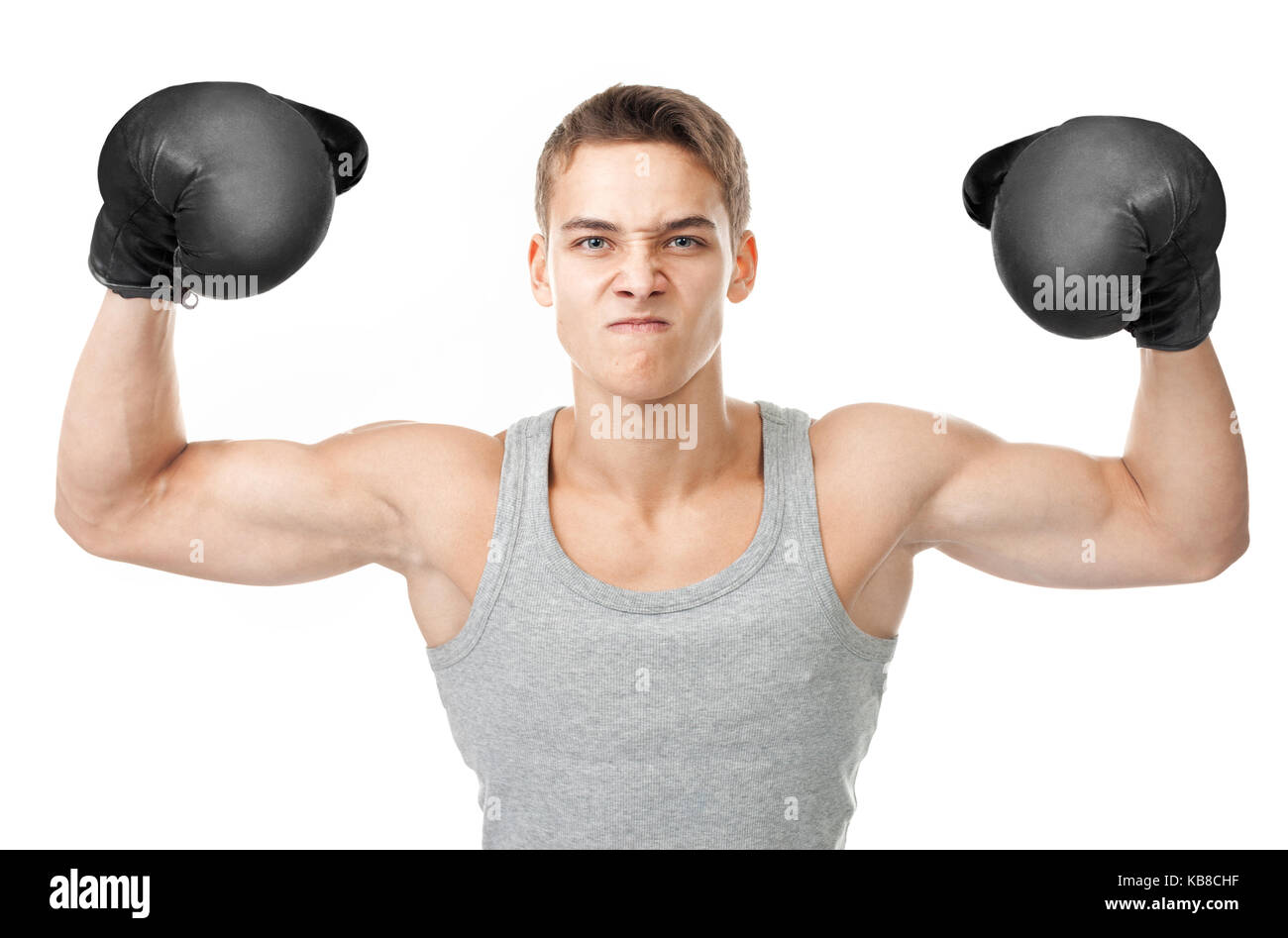 Portrait of angry young boxer showing biceps isolated on white ...