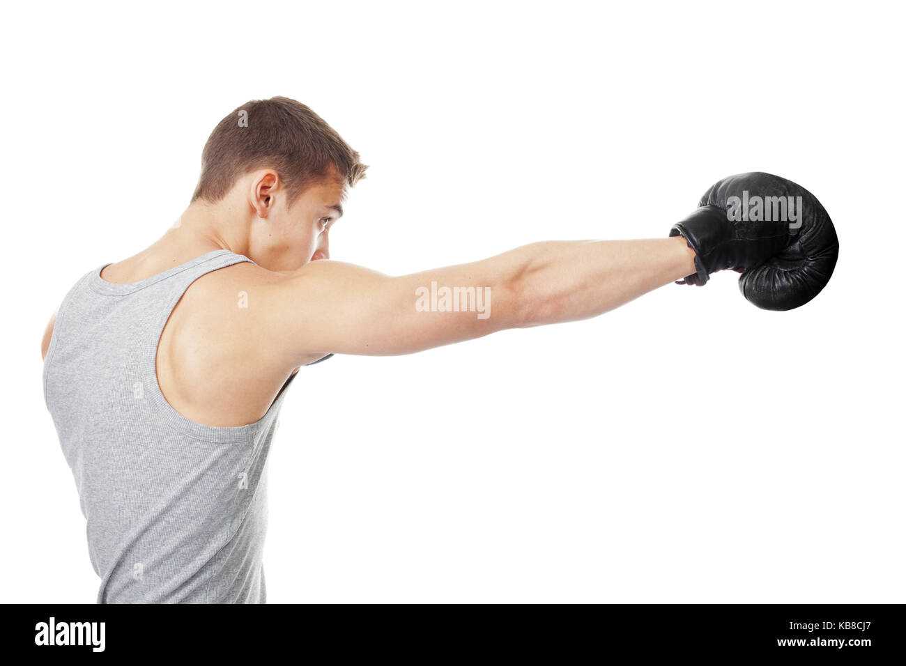 Side view portrait of young boxer making punch isolated on white ...