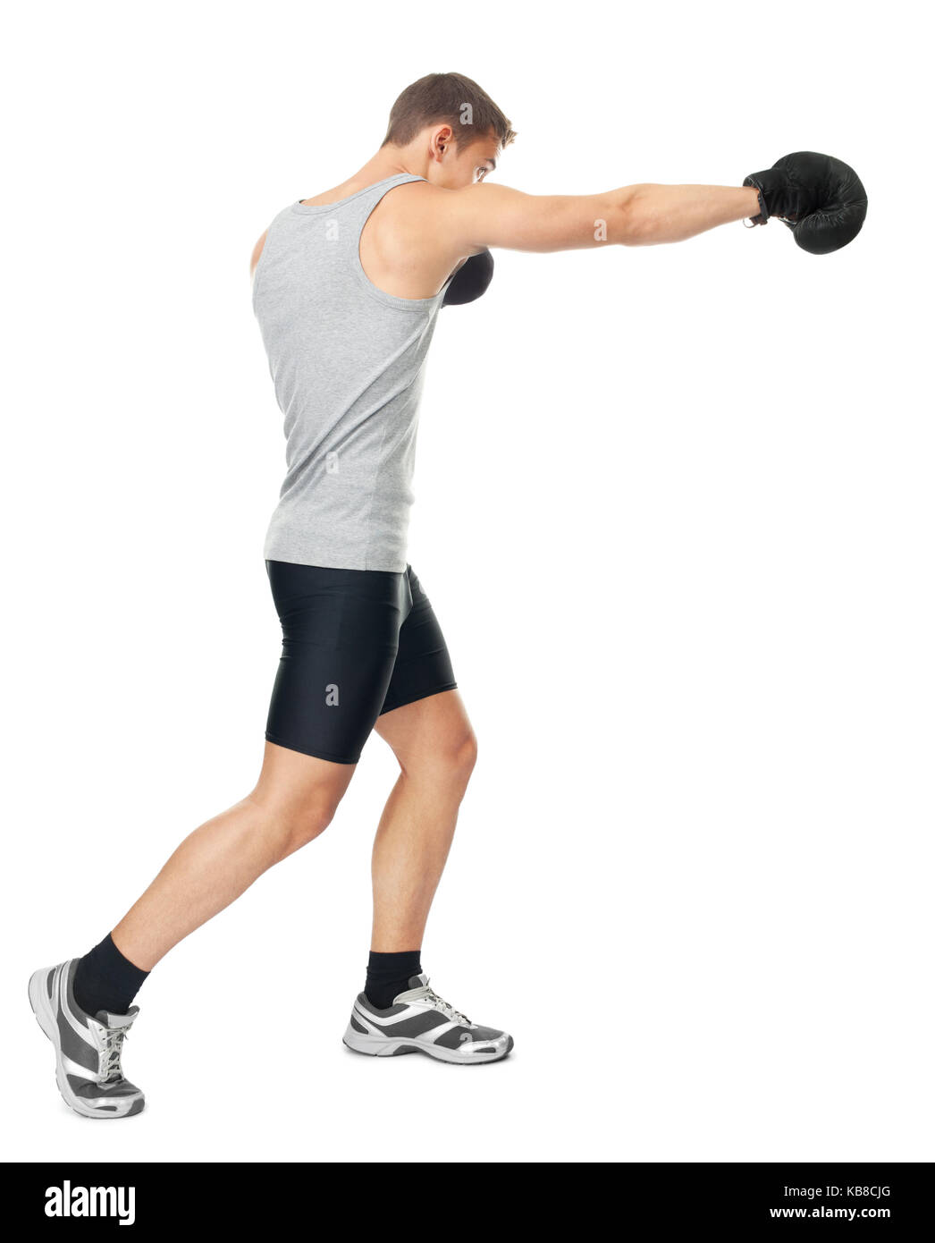 Full length side view portrait of young boxer making punch isolated on ...