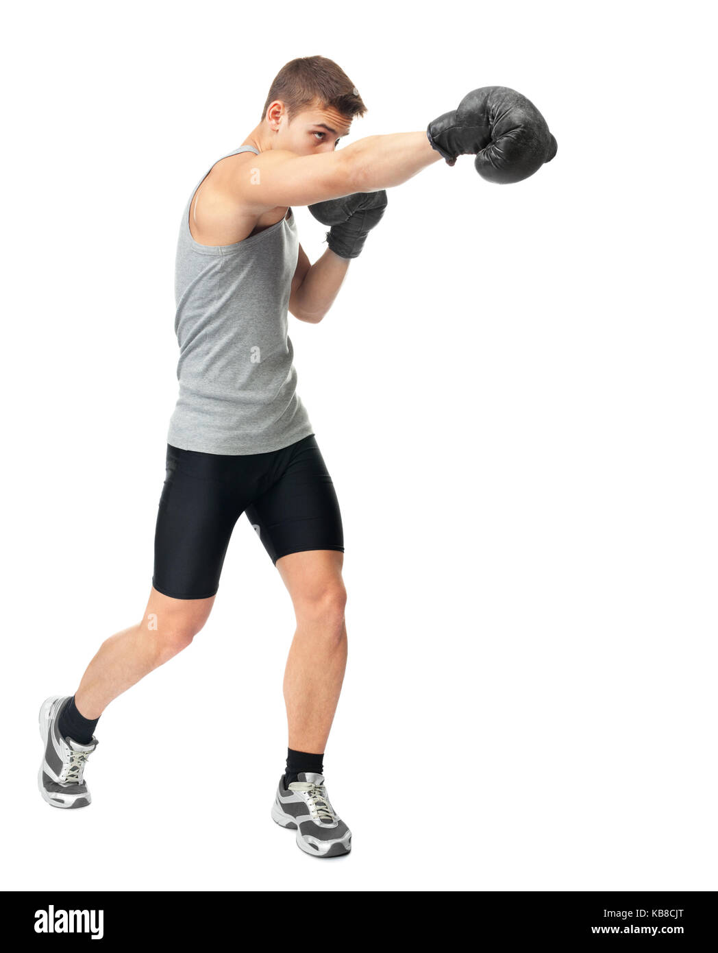 Full length portrait of young boxer making punch isolated on white ...