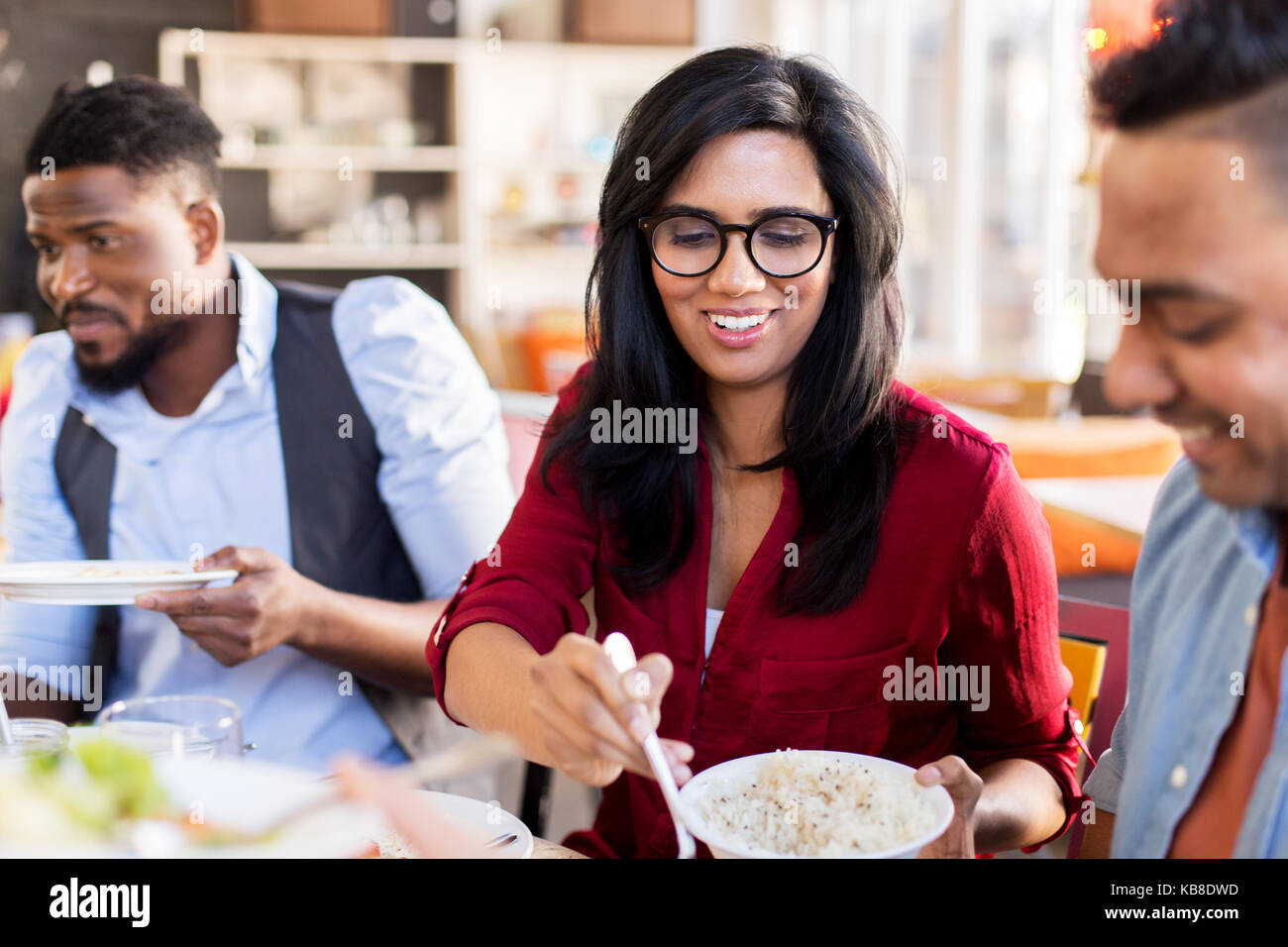 happy friends eating at restaurant Stock Photo - Alamy