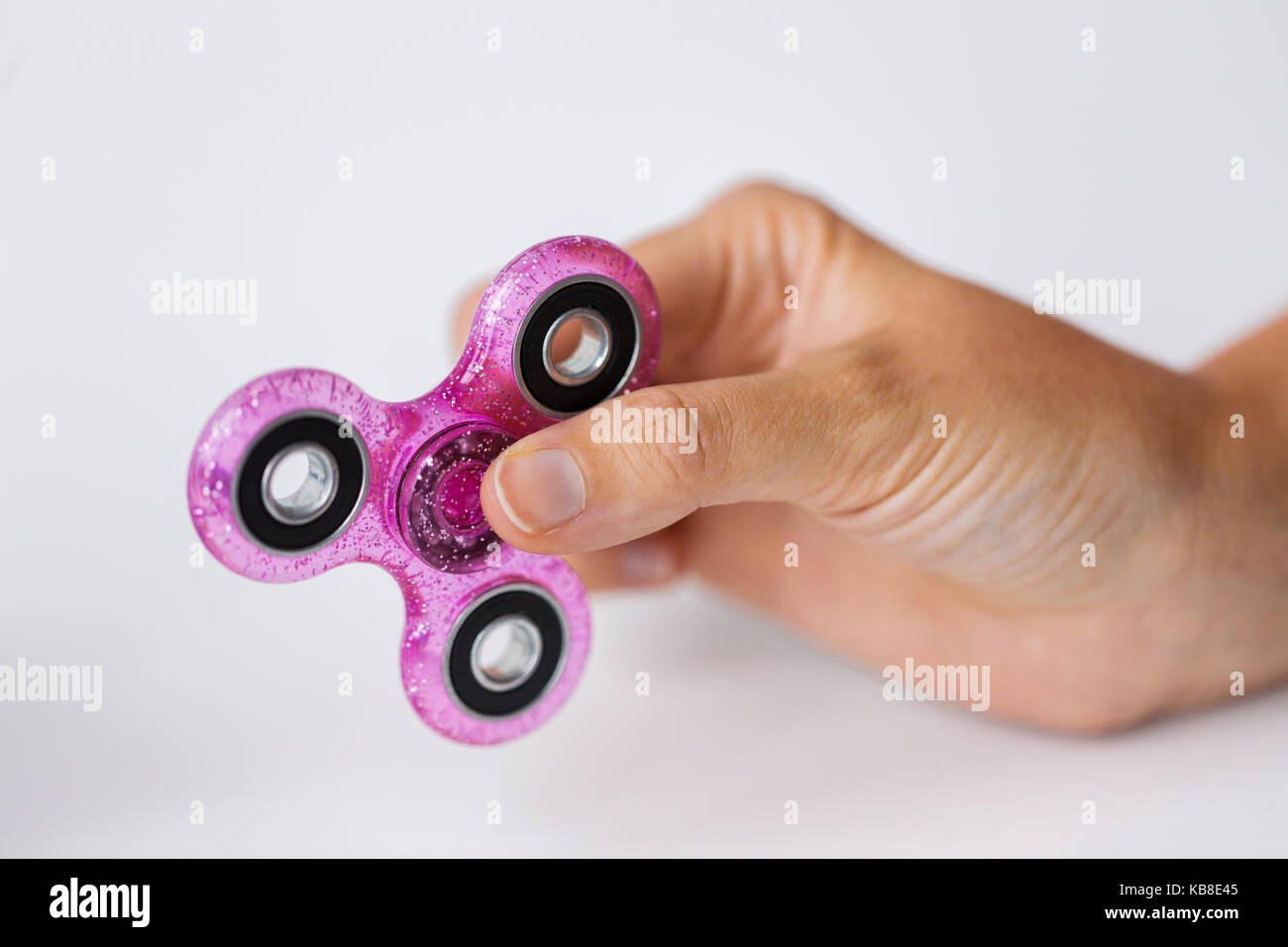 close up of hand playing with fidget spinner Stock Photo - Alamy