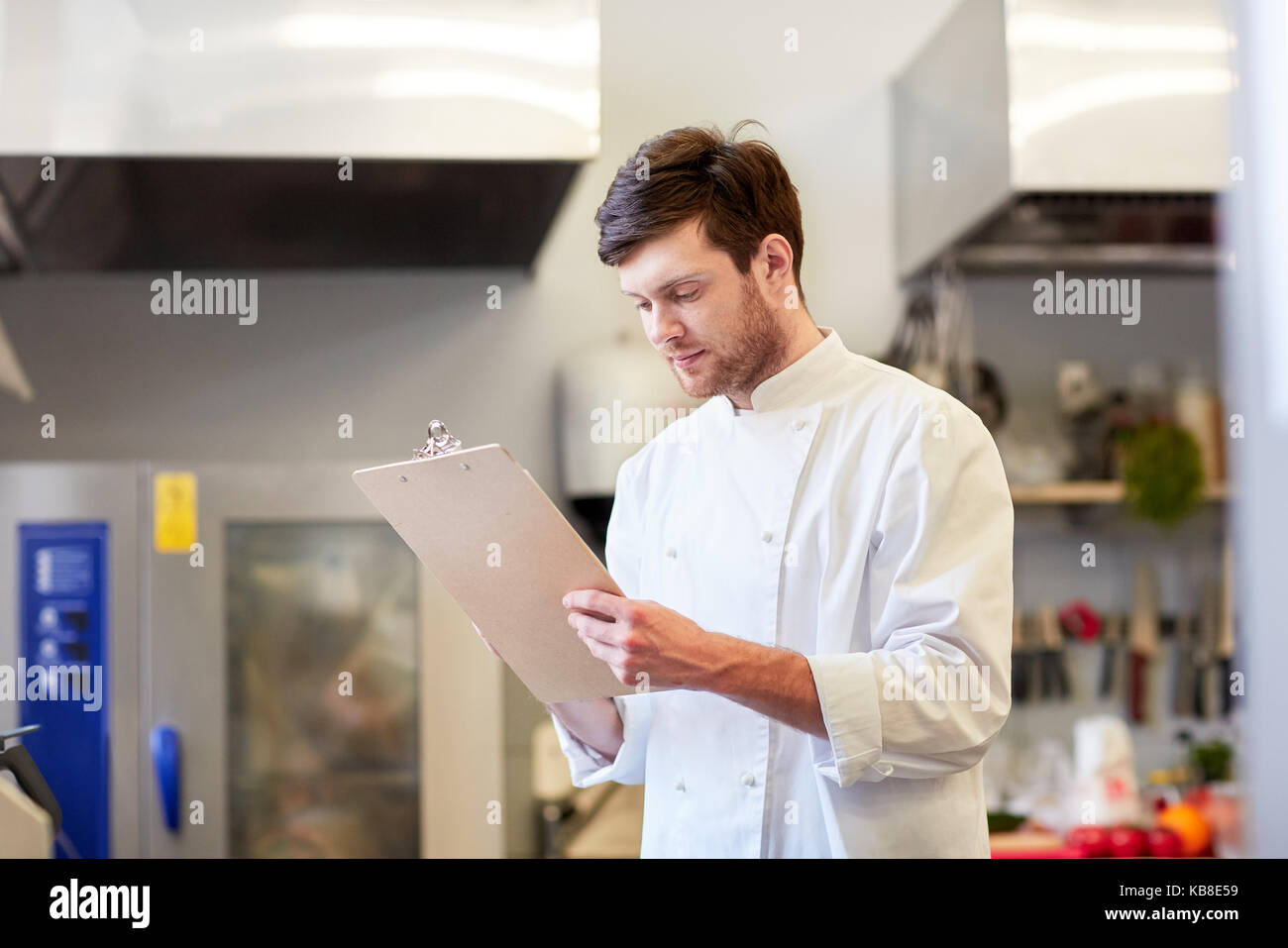 chef with clipboard doing inventory at restaurant Stock Photo - Alamy
