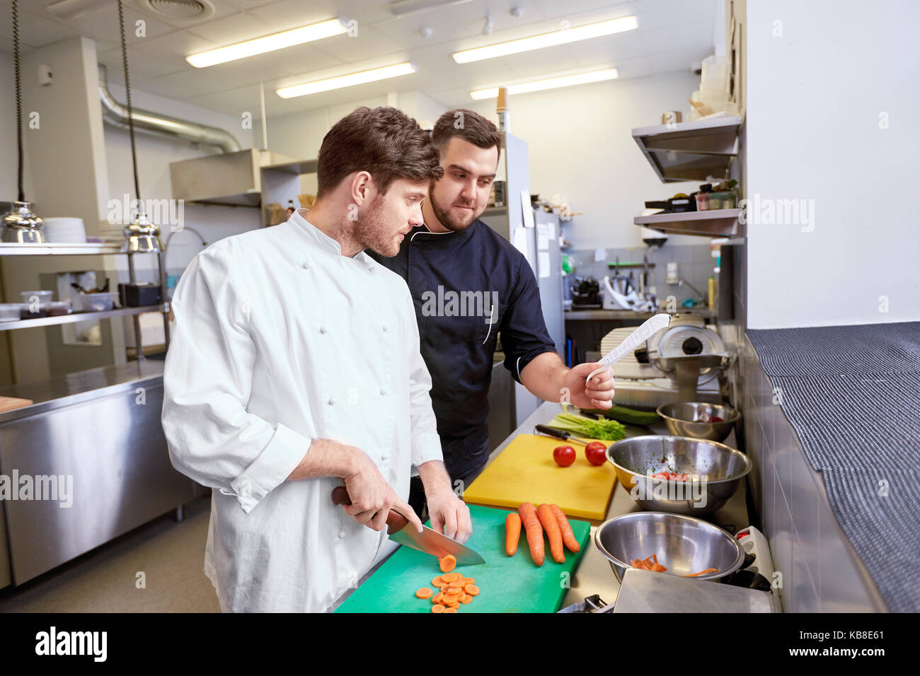 chef and cook cooking food at restaurant kitchen Stock Photo - Alamy