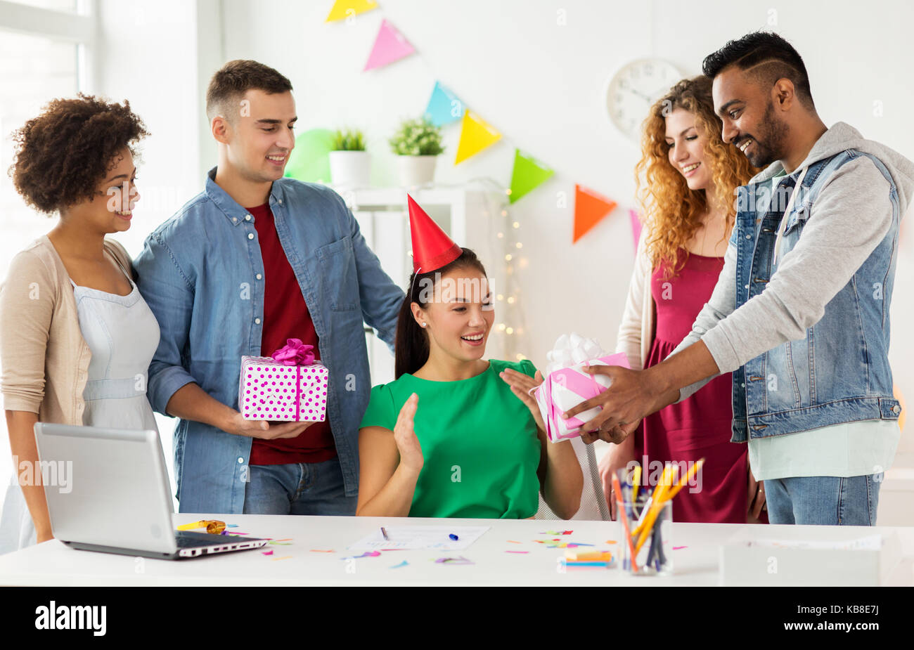 team greeting colleague at office birthday party Stock Photo - Alamy